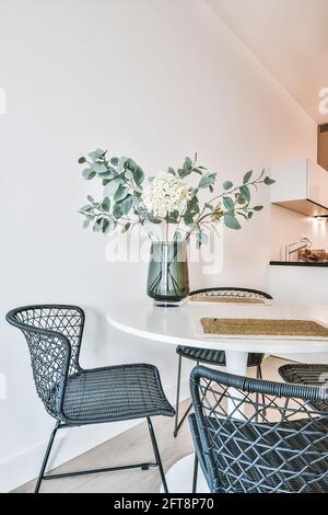 Comfortable sofa with cushions placed near wall with frames in stylish ...