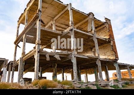 Old abandoned unfinished building damaged by time, wind and rain ...