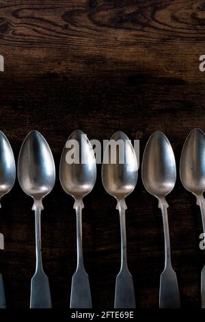 Metal spoons lying on the kitchen table in the daylight Stock Photo - Alamy