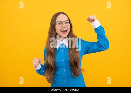 Education is the key to success. Happy tween girl show winning gesture ...