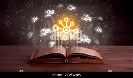 Open book with social networking icons above Stock Photo - Alamy
