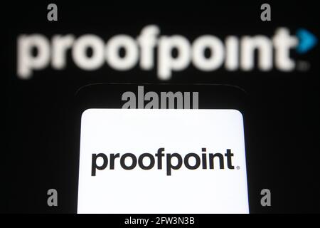In this photo illustration, a Proofpoint logo is seen displayed on a smartphone and in the ...