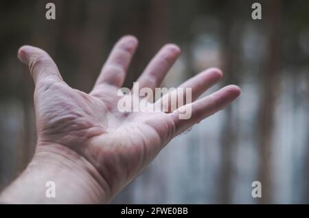 Male open hand gesture on a dark background Stock Photo - Alamy