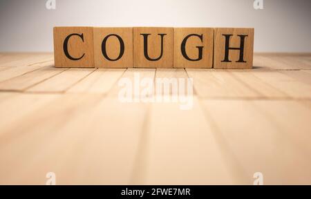 The word Cough was created from wooden cubes. Health and life Close up ...