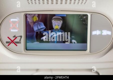 Flight attendant showing how to use an oxygen mask in case of emergency ...