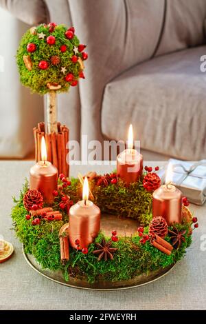 Advent wreath made of moss, cinnamon sticks and rosa canina twigs ...