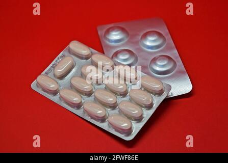 Blister packs of pills on red background Stock Photo - Alamy