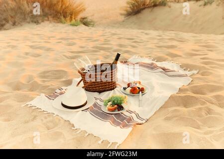 Blanket with fruits on sandy beach, picnic concept Stock Photo - Alamy
