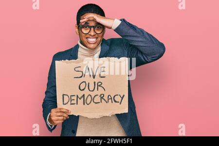 Young handsome hispanic man at political campaign election holding cuba ...