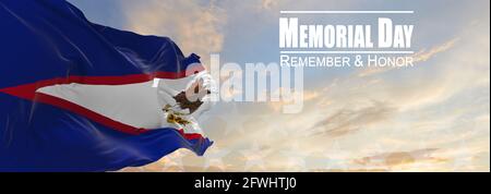 Flag of American Samoa being waved in the breeze against a sunset sky ...