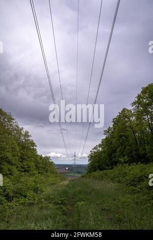 High voltage power lines run through an industrial landscape Stock ...
