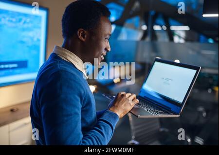 One manager works on laptop in night office Stock Photo - Alamy