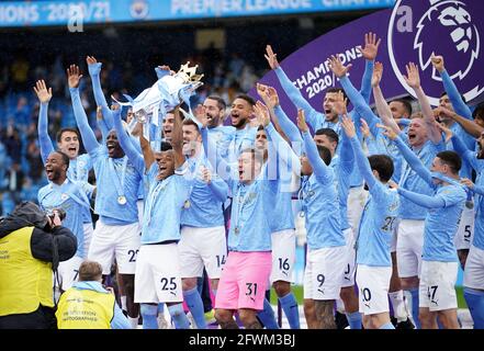 Manchester City's Fernandinho (centre) lifts the Premier League trophy ...
