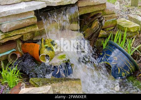 Garden waterfall feature decorated with broken pottery Stock Photo - Alamy
