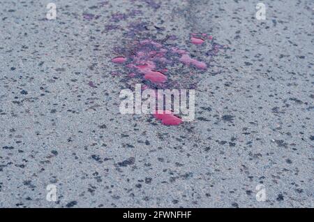 A pool of blood on the asphalt. Splattered human blood on the road. Top ...