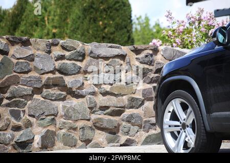 Natural stone wall as a property line and sight protection Stock Photo ...
