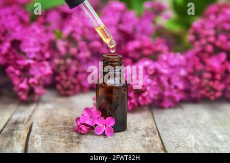Lilac essential oil in a small bottle. Selective focus. Nature Stock ...