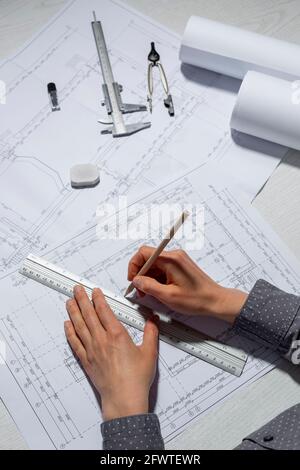 pencil, hand, blueprints on desktop Stock Photo - Alamy