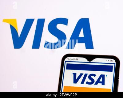 In this photo illustration, VISA logo seen displayed on a smartphone ...