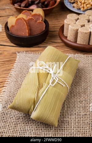 Pamonha, a traditional brazilian corn cake, served on glass plate over ...