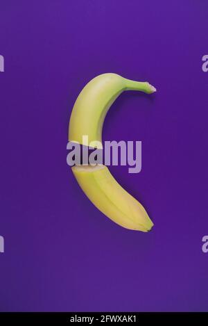 Trendy summer pattern of fresh bananas on a pink background. The ...