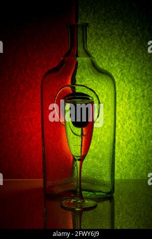 Still life with glass objects with colored spots on a reflective ...
