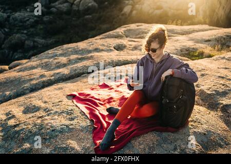 Joyful young female hiker with curly hair in casual outfit and ...