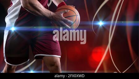 Composition of midsection of basketball player holding ball with copy ...