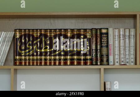 Volumes of Islamic religion books placed on a shelf of a school library ...