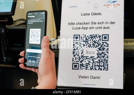 Luca app on a smartphone scans a Luca QR code at the entrance to a ...