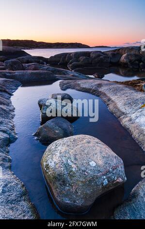 A beautiful seascape in Amundon, Sweden, with sunlight on the water ...