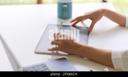Side view of businesswoman hand with stylus pen working on digital ...