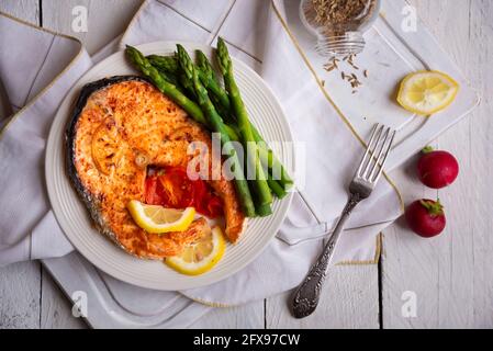 Salmon stake cooked with lemon and asparagus Stock Photo - Alamy