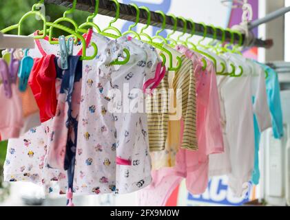 Closeup shot of baby cloth laundry hanging outside on a sunny day Stock ...