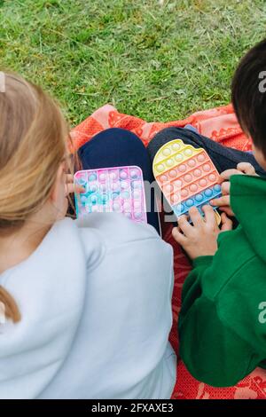 top view of kid hands Playing with Colorful Clay in outdoor Playground ...