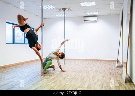 male acrobat balancing on pole high up in the air Stock Photo - Alamy