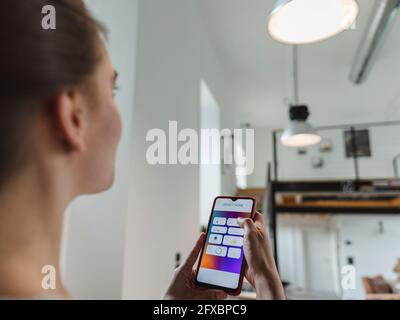 Person Controlling Smart Light With Remote Control Stock Photo - Alamy