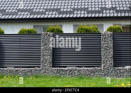 Free standing mesh gabion filled with granite rocks standing on ...