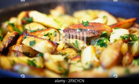 Fried village potatoes with herbs Stock Photo - Alamy