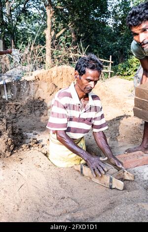 Men making clay bricks by hand in a rural village in Nayagarh, Odisha ...