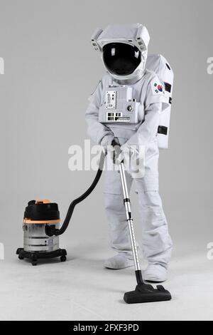 astronaut cleaning floor with vacuum cleaner, white background Stock ...