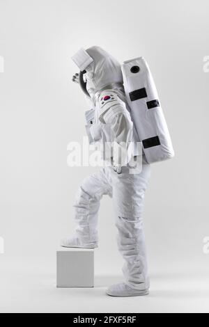 astronaut with raised legs, white background Stock Photo - Alamy