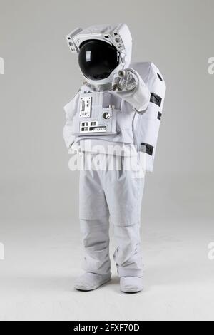 Astronaut pointing using finger, white background Stock Photo - Alamy