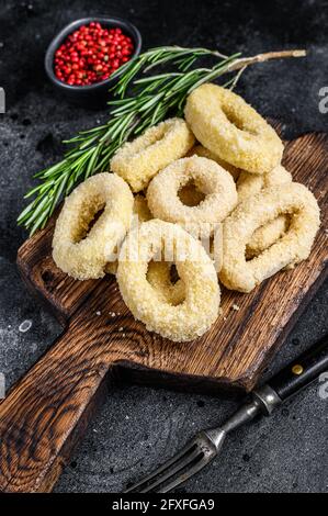 Raw crispy squid rings in breadcrumbs package set, on gray stone table ...