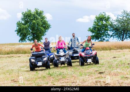 Friends driving off-road with quad bike or ATV and UTV vehicles Stock ...