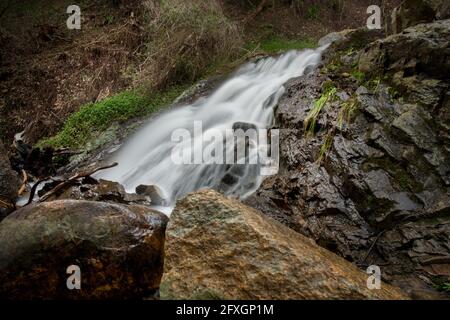 A cascading waterfall in a mountain in the Paarl Region of the Western ...