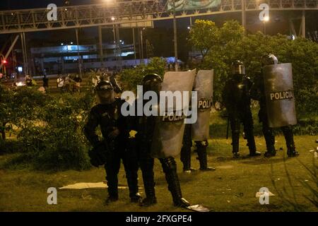 Bogota, Colombia. 26th May, 2021. People cover themselves with shields ...
