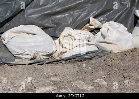 Temporary flood protection wall made of box barriers and sandbags ...