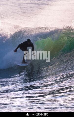 The surfer riding a wave in the early morning. Maroochydore, Australia ...