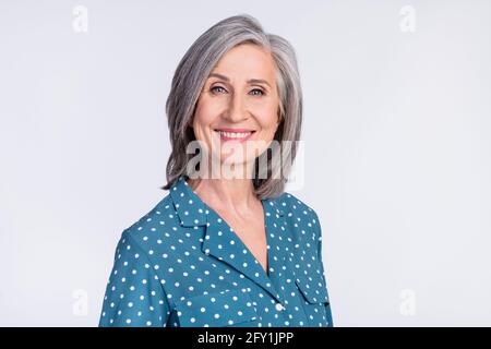 Photo of charming positive half turned girl beaming smile empty space ...